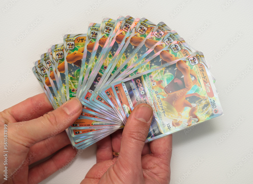 Hamburg, Germany - 01072023: male hands holding a pokemon trading card ...