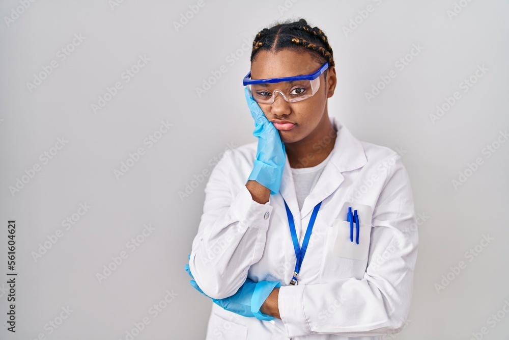 African american woman with braids wearing scientist robe thinking ...