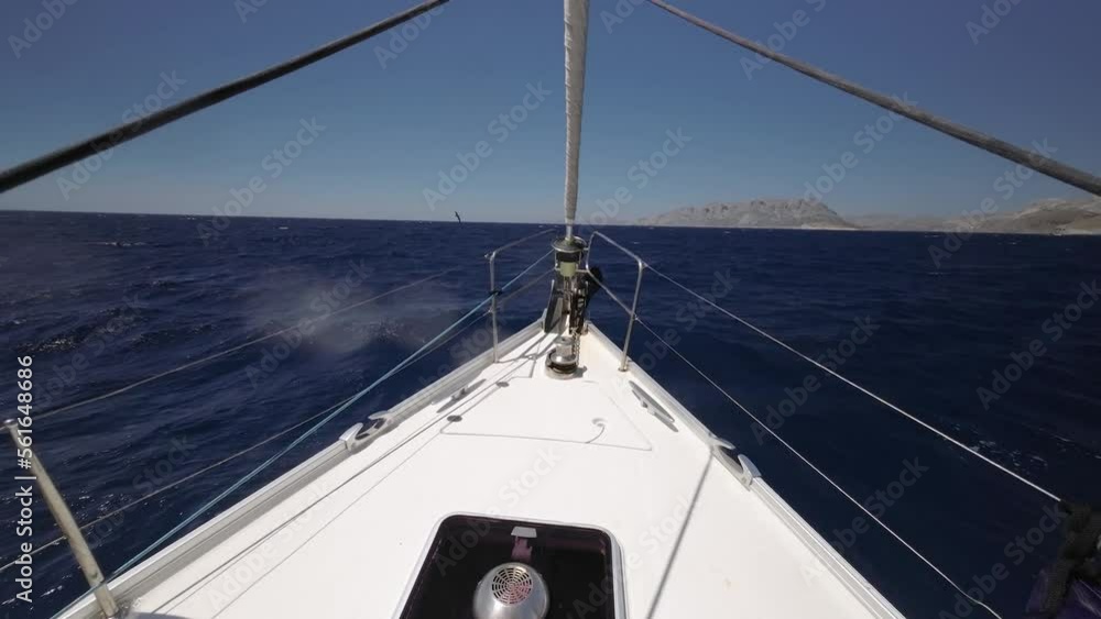 Floating sailing yacht with spread sails splitting the sea waves and an ...