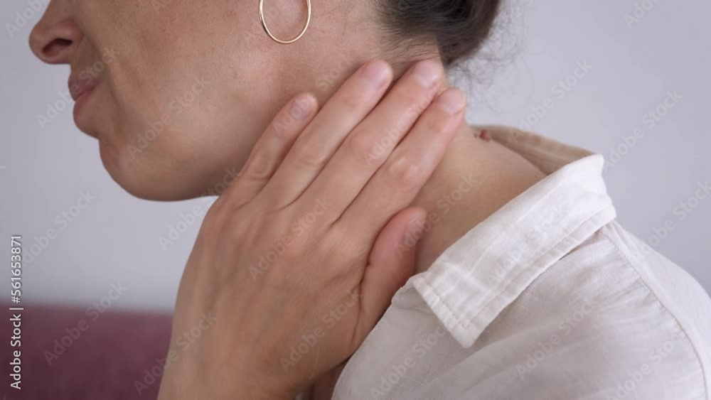 Lady with painful face touching neck. A view of painful female face ...