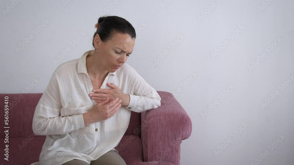 Lady touching chest with heart ache. A stressed woman touch her chest ...