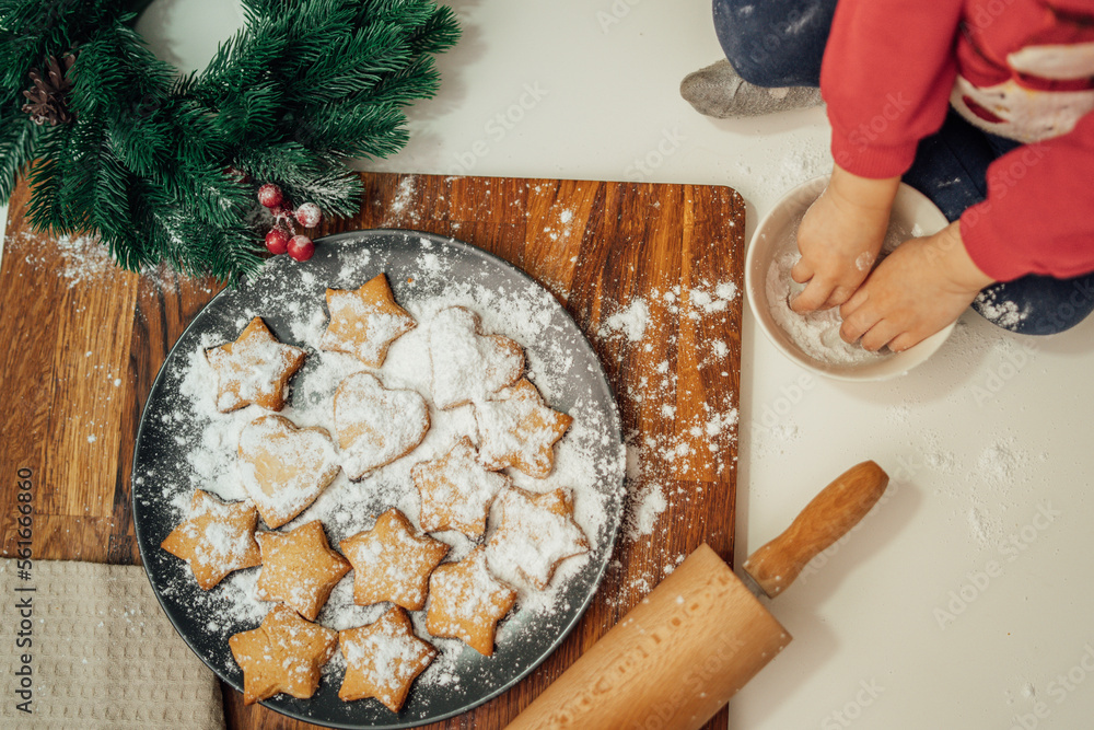 Top and side view of mother and daughter preparing gingerbread cookies ...