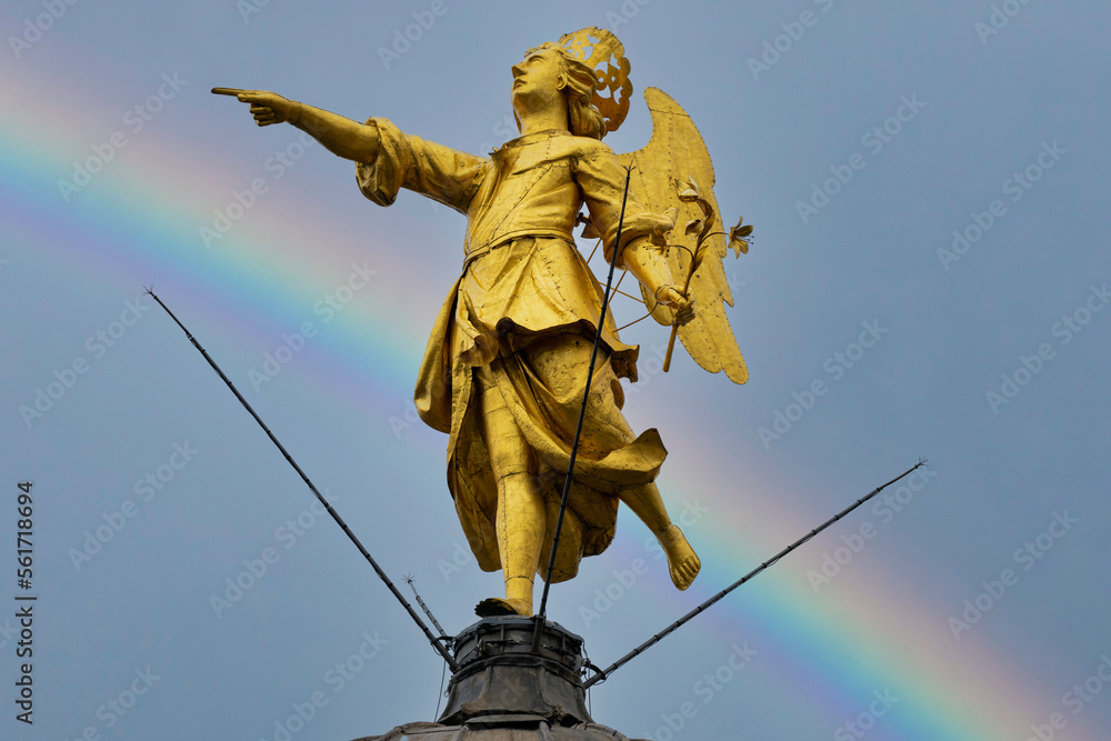 The golden angel at the top of the Udine city castle. The bronze statue ...