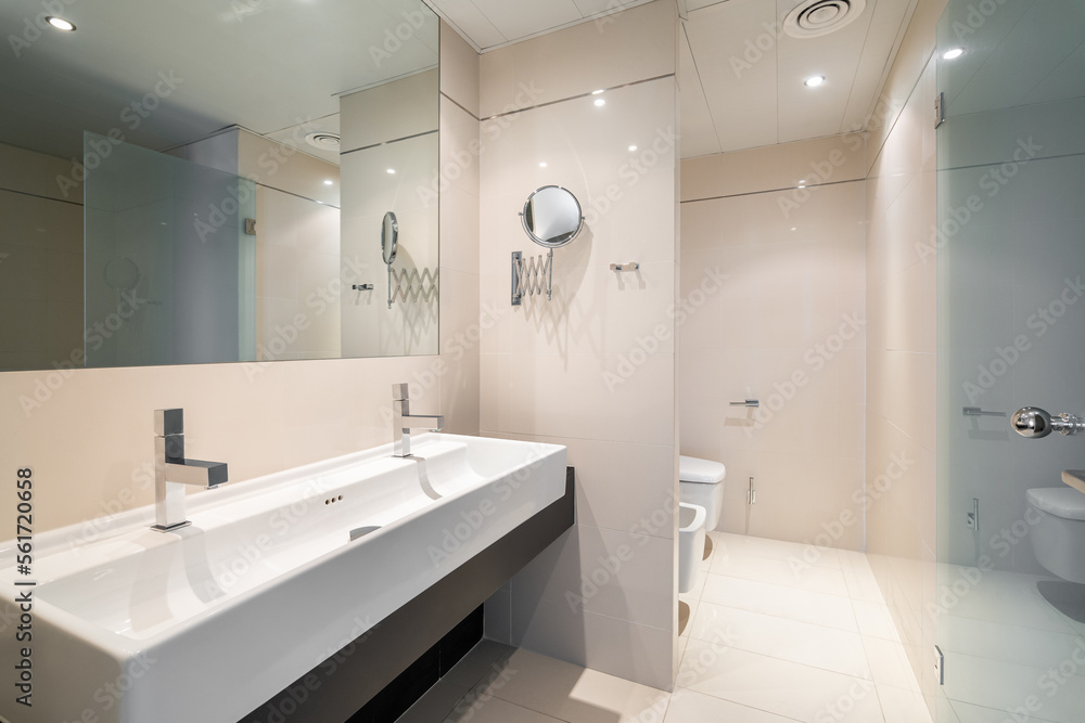 Large bathroom is divided into zones with large square full length ...