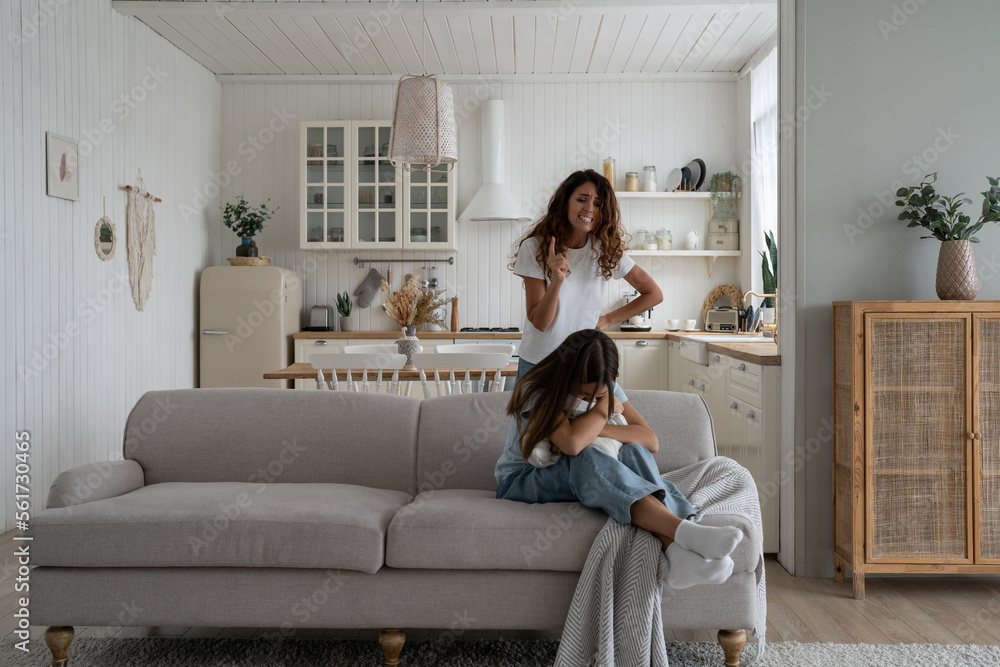 Angry parent, mother yelling at teen girl daughter while arguing at home. Problems between ...