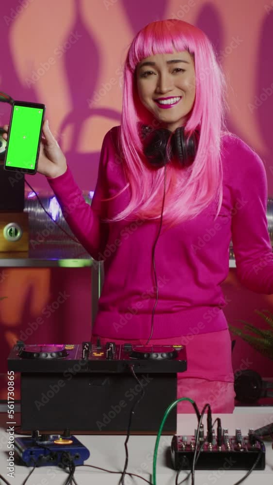 Vertical video: Smiling musician presenting green screen mock up phone ...