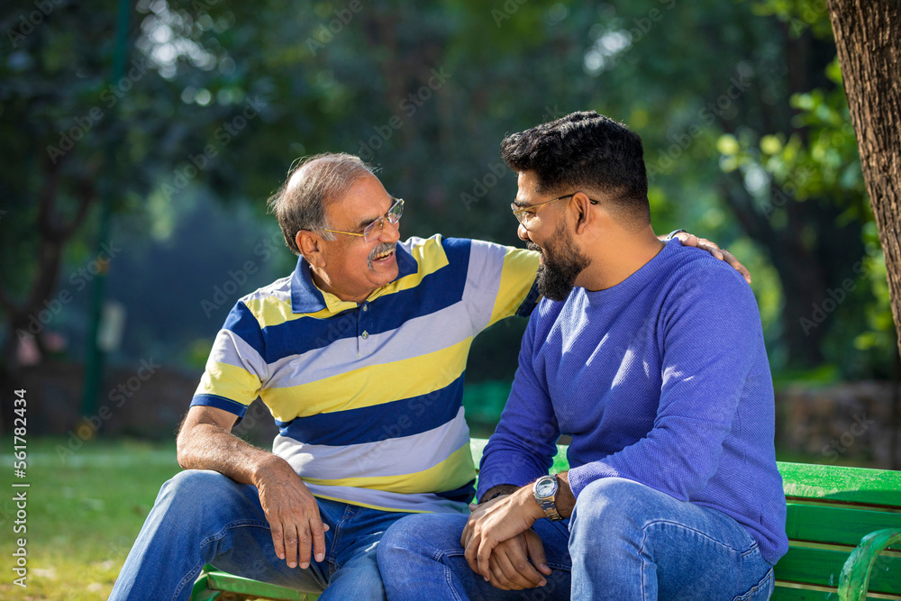 Old indian father with his young son spending time at park. Stock Photo ...
