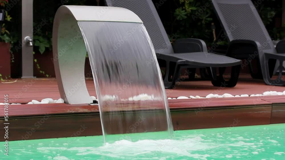 Stainless steel swimming pool wall waterfall jet on luxury resort ...