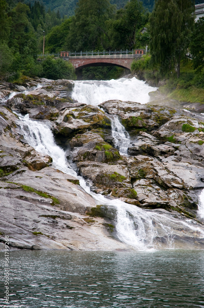 The waterfall through Hellesylt, Stranda, Norway, a small ferry port ...