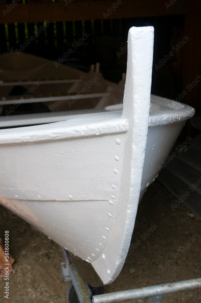 Traditionally built Norwegian wooden rowing boat, painted white. Inside ...