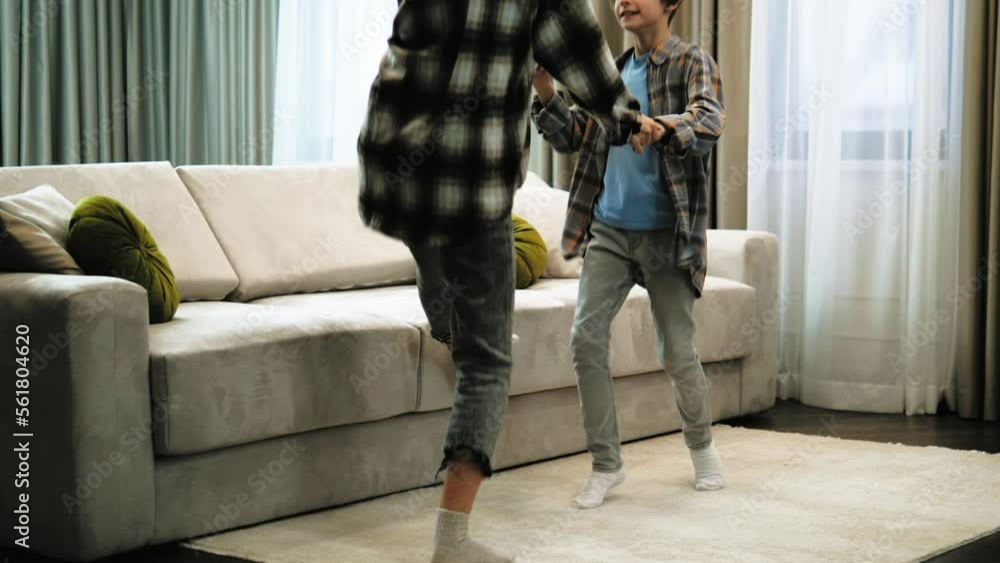 Happy joyful brother and sister siblings dancing, having fun at home ...