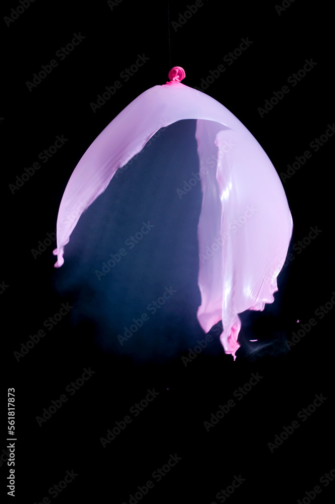 A smoke filled pink balloon bursting when shot with an air rifle. Sound ...