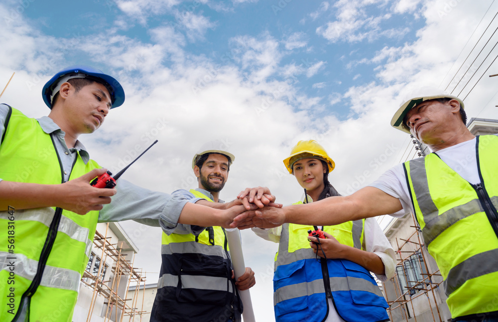 Group of contractors, engineers and formats in safety vests with ...