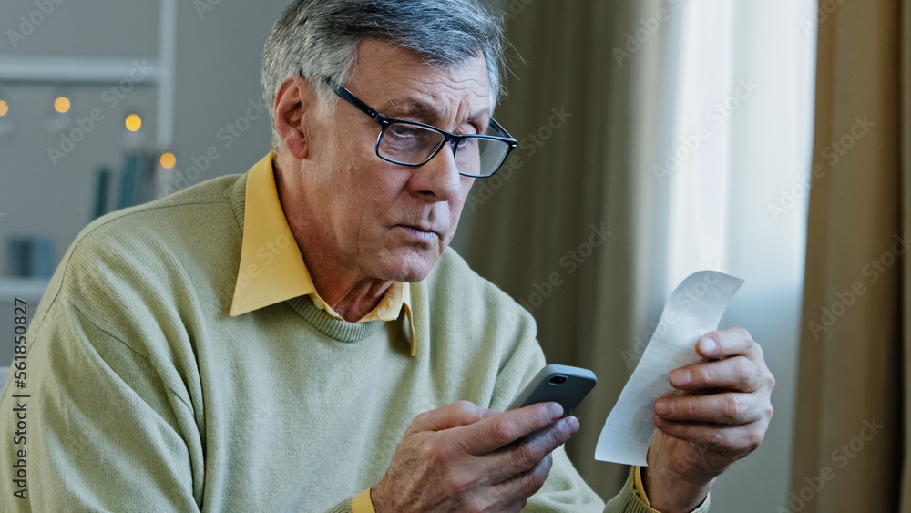 Caucasian old 60s man senior mature grandfather holding smart phone ...