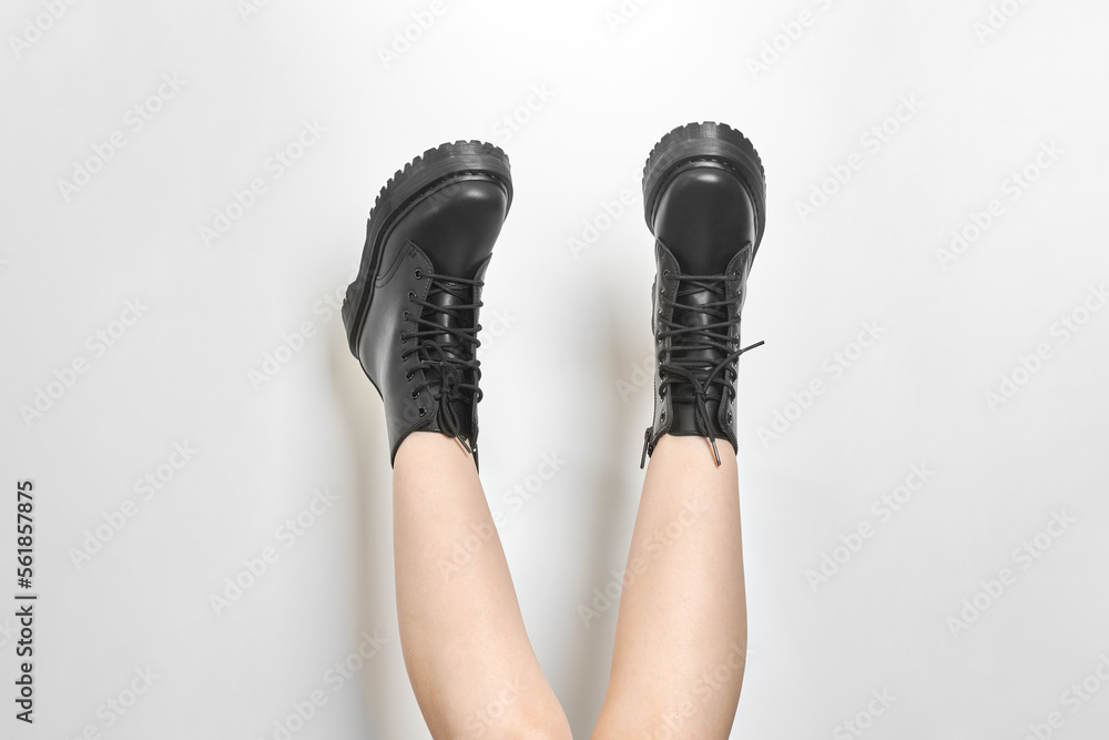 Woman legs in black combat boots on high heel platform with lug soles ...