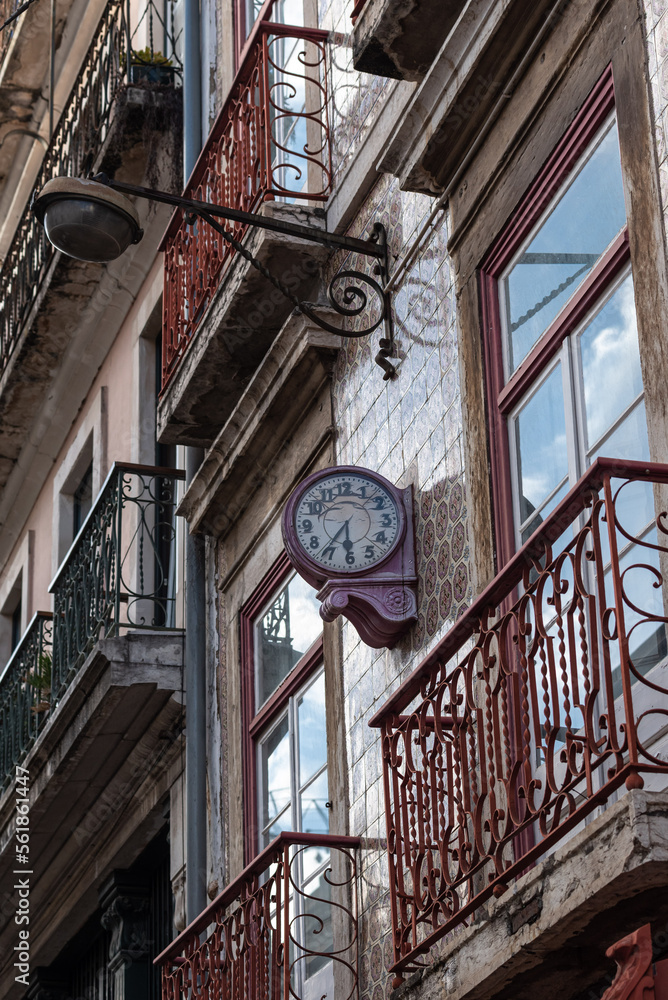Wall mounted public clock on tile clad building Stock Photo | Adobe Stock