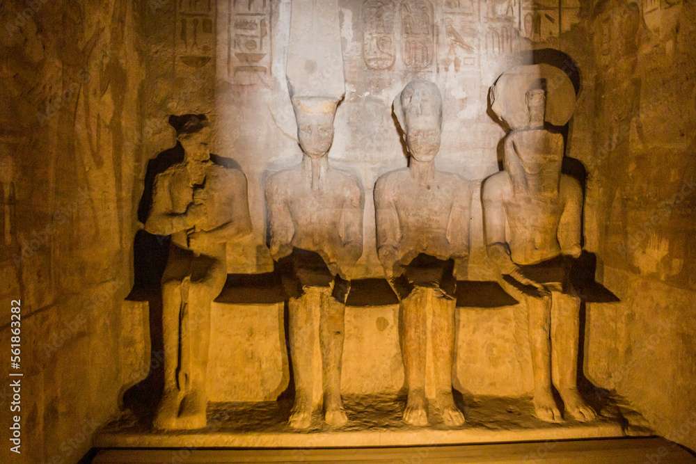 Photo Statues of Ptah, Amun Ra, king Ramesses II and Ra-Horakhty illuminated by the rays of the ...