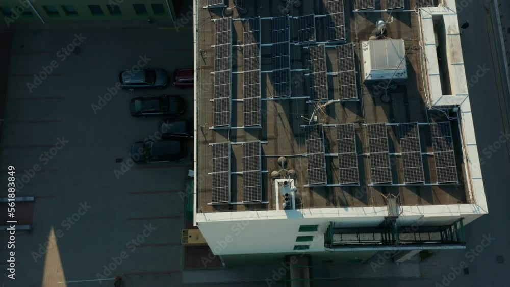 Aerial view modern building with solar panels on flat roofs, showing ...