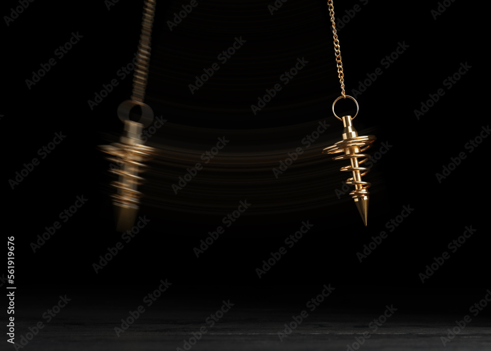 Hypnosis session. Pendant swinging over surface on black background ...