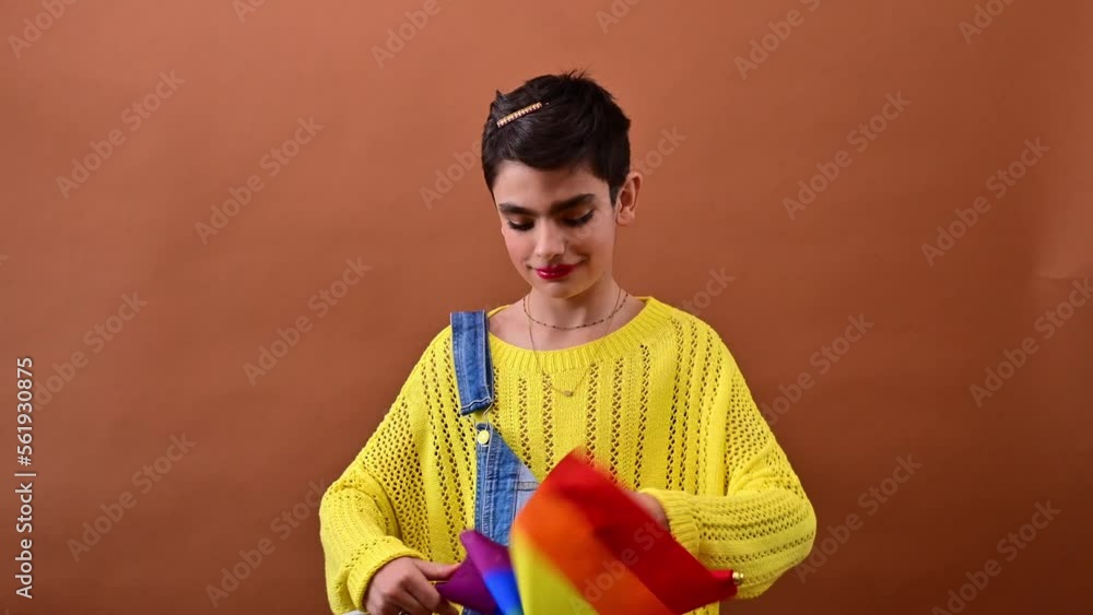 Young boy feeling girly and holding a pride flag. Gender confusion in ...