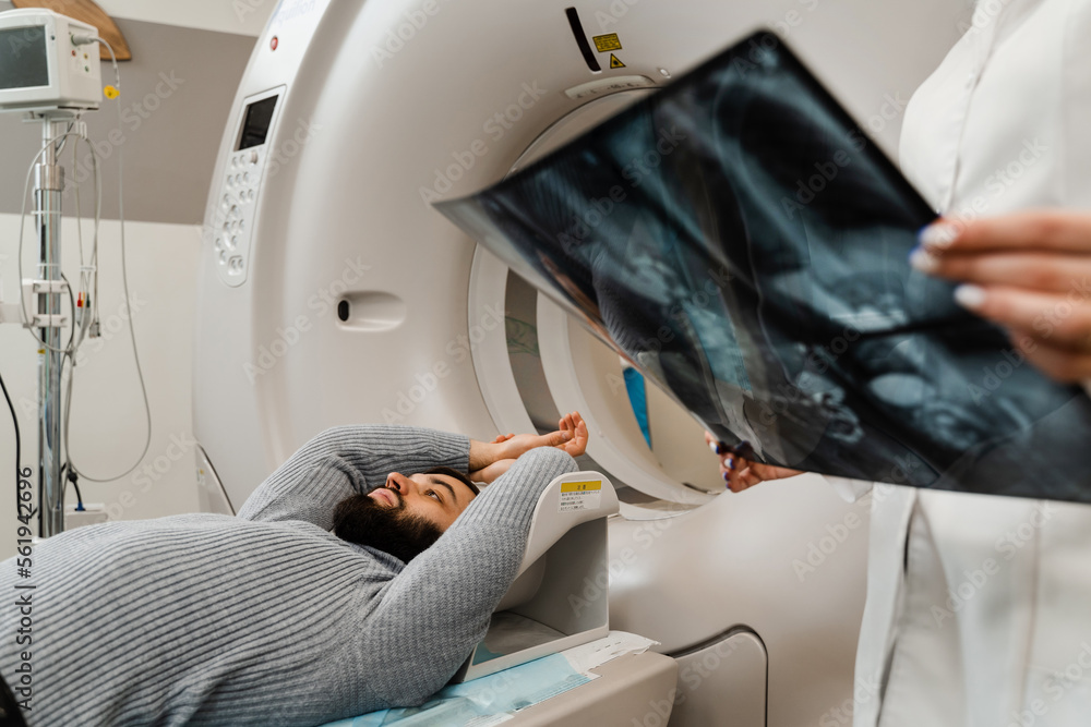 CT scan of abdomen of man in medical clinic. Man is doing computed ...