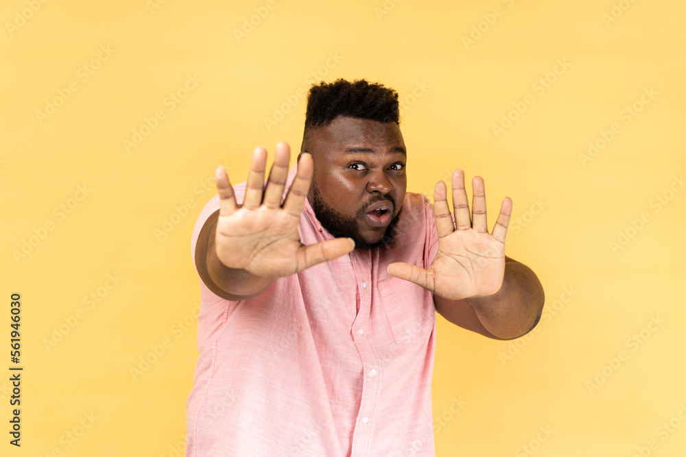 No, it's scary. Portrait of frightened shocked man wearing pink shirt ...