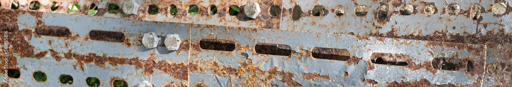 Horizontal long piece of rusted steel building stud with holes ...