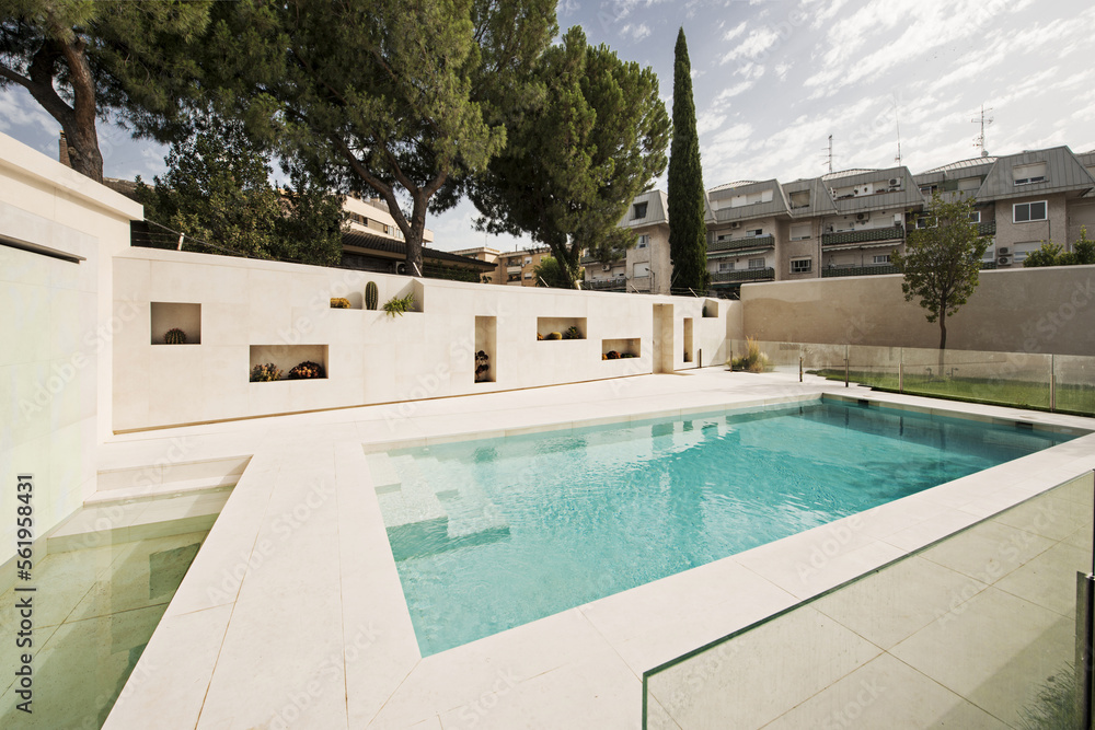 Foto de Beautiful pool of a luxury detached house with marble tiles and ...
