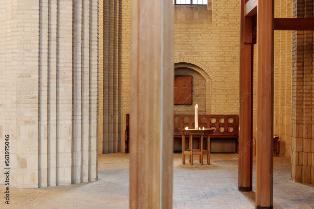 Interior view at the aisle and nave area with single table and candle ...