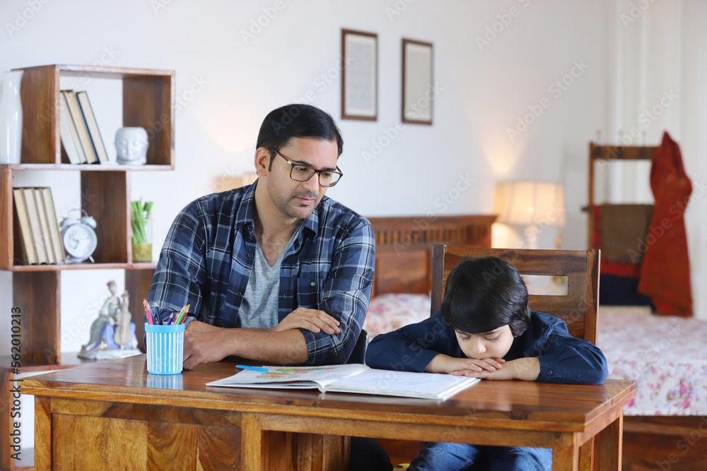 Portrait of Indian family sitting together father advising son for ...