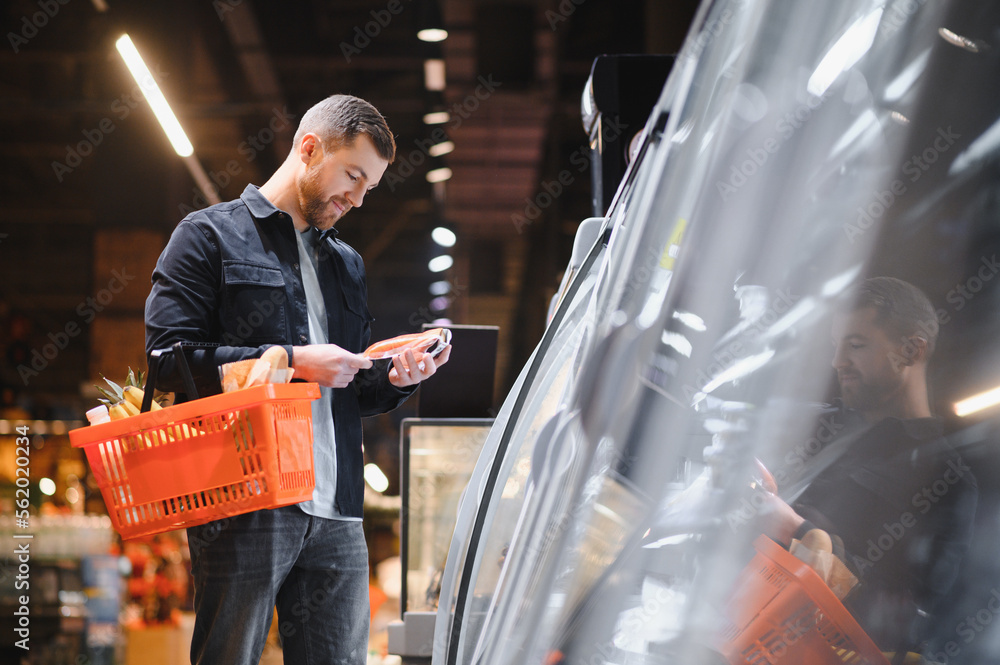 Man shopping in a supermarket Stock Photo | Adobe Stock