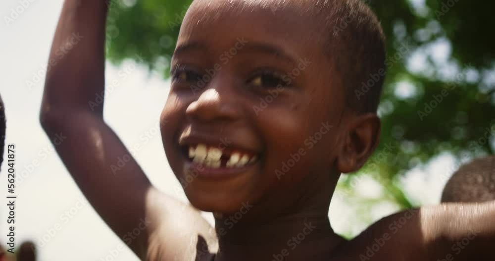 Portrait of an African Little Boy Jumping and Dancing with Other Kids ...