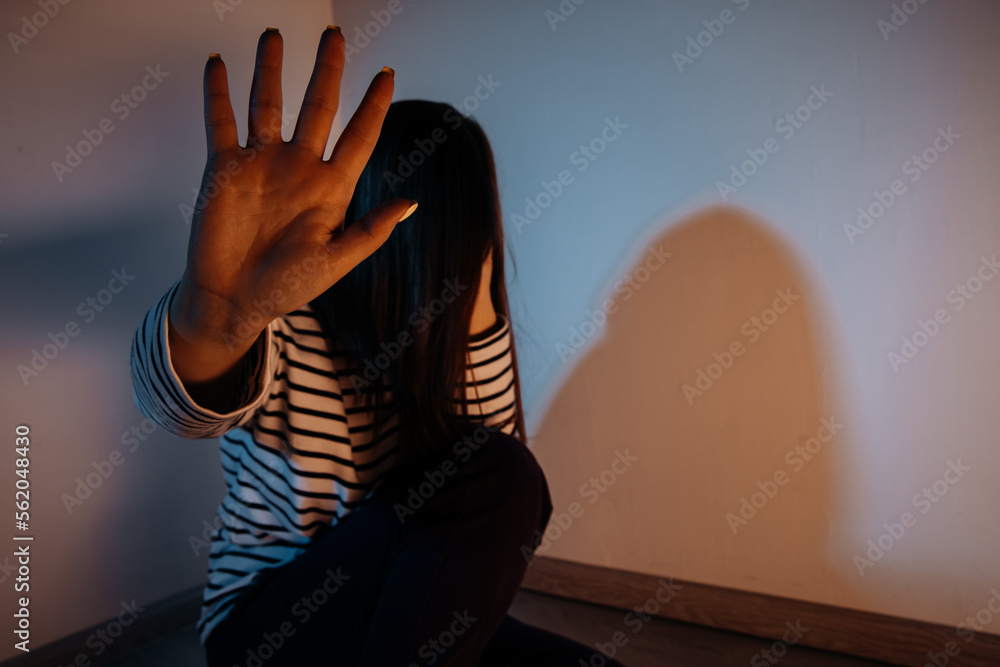 Girl with a raised hand making a stop sign gesture. Violence ...