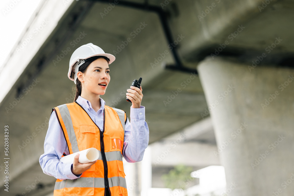 Foto de Asian engineer worker woman or architect looking construction ...
