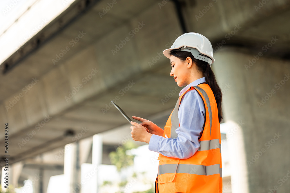 Asian engineer worker woman or architect looking construction with ...