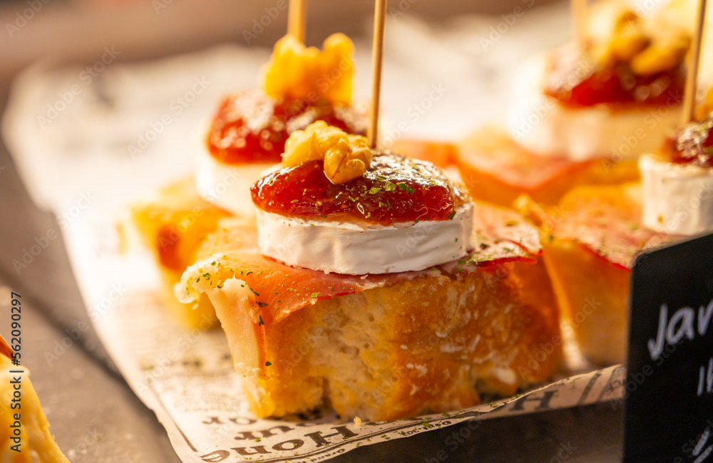 Typical snack of Basque Country, pinchos or pinxtos skewers with small ...