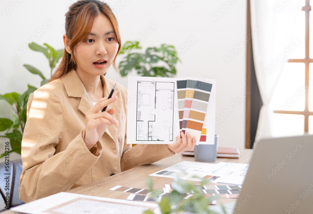 Interior designer presenting blueprint of residence project and color ...