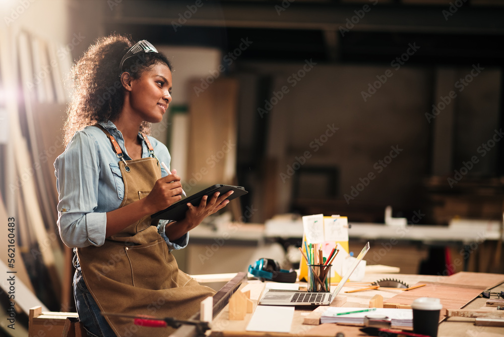Young attractive african american female carpenter in wood working in ...