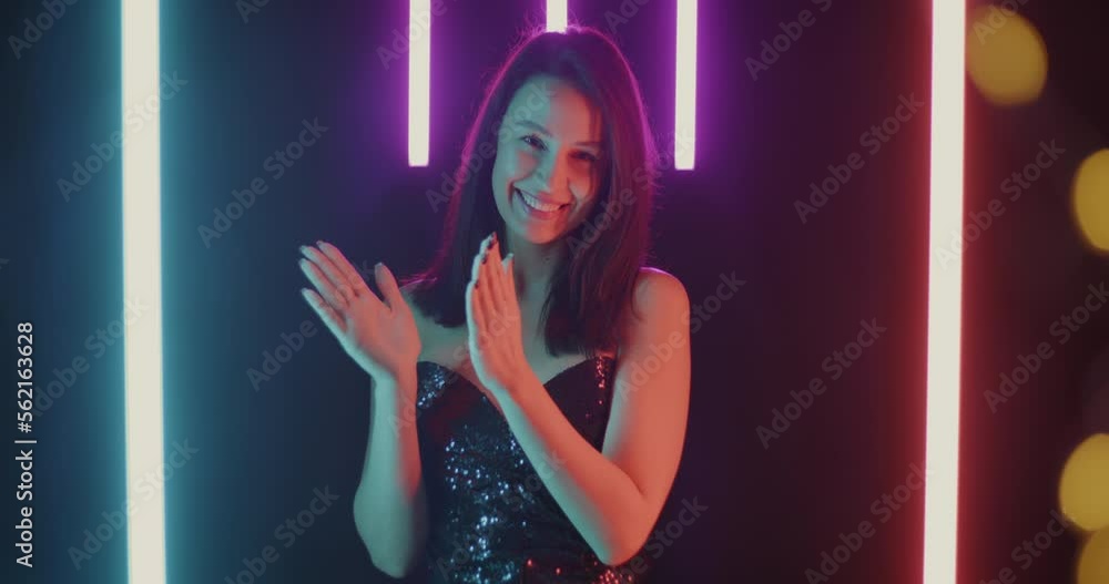 Slow motion of happy lady clapping hands and looking at camera ...