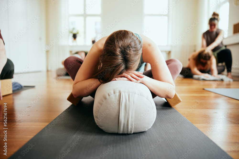 Woman practicing the supported butterfly pose Stock Photo | Adobe Stock