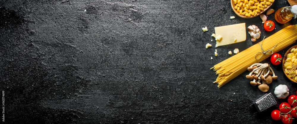 Different types of raw paste with Parmesan, mushrooms and tomatoes ...