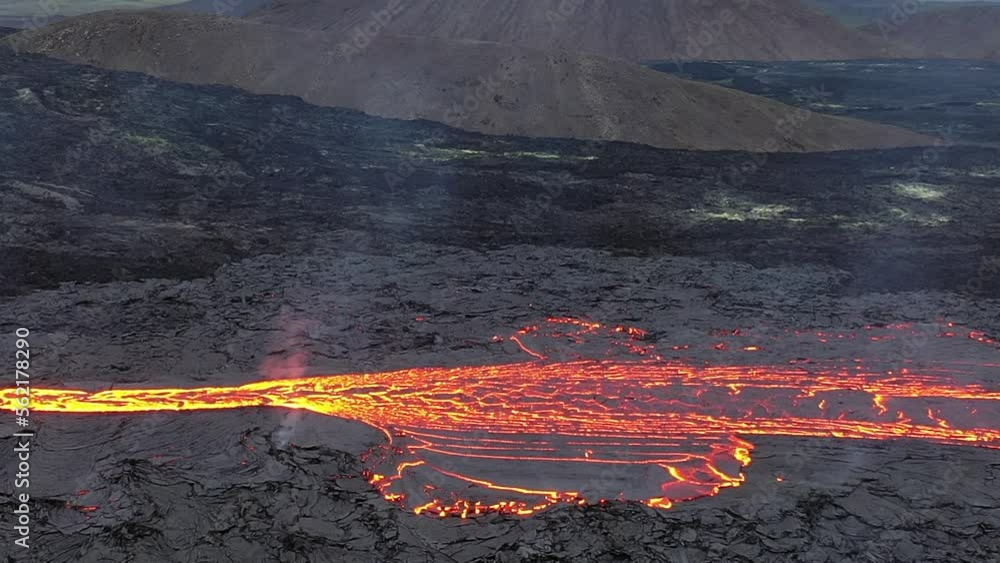 Volcanic eruption. Beautiful hot molten lava stream river in slow ...