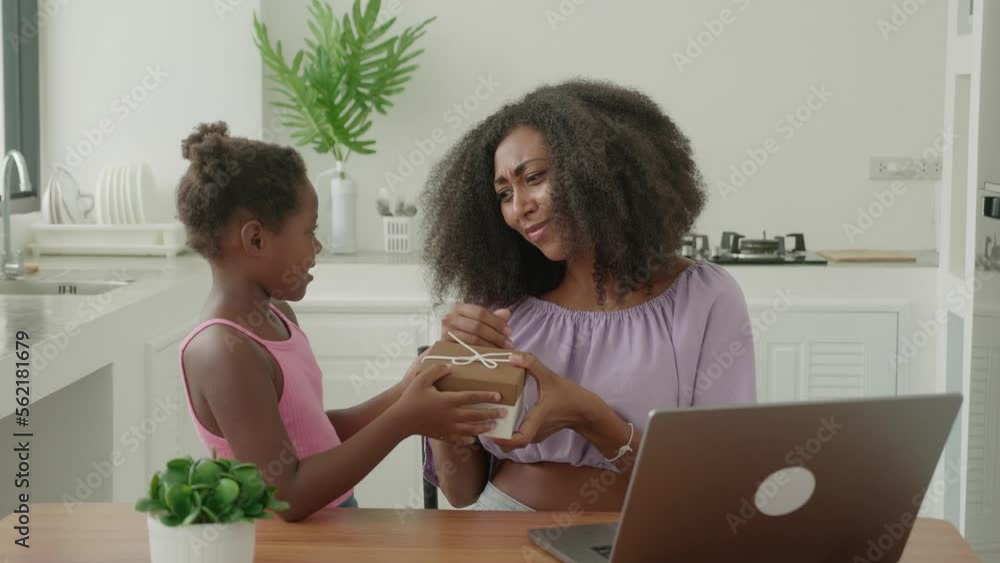Multitasking young African mother freelance worker, entrepreneur ...