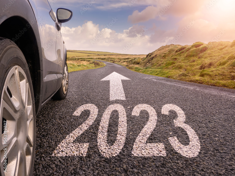 Sign 2023 and directional arrow on small asphalt country road and a ...