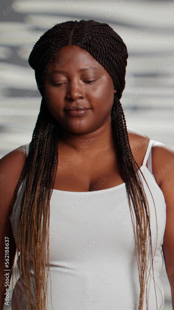 Vertical video: Female model embracing imperfections in studio, posing ...