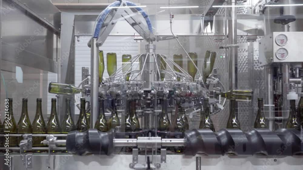 Operation of a wine bottling conveyor with overturning green empty ...