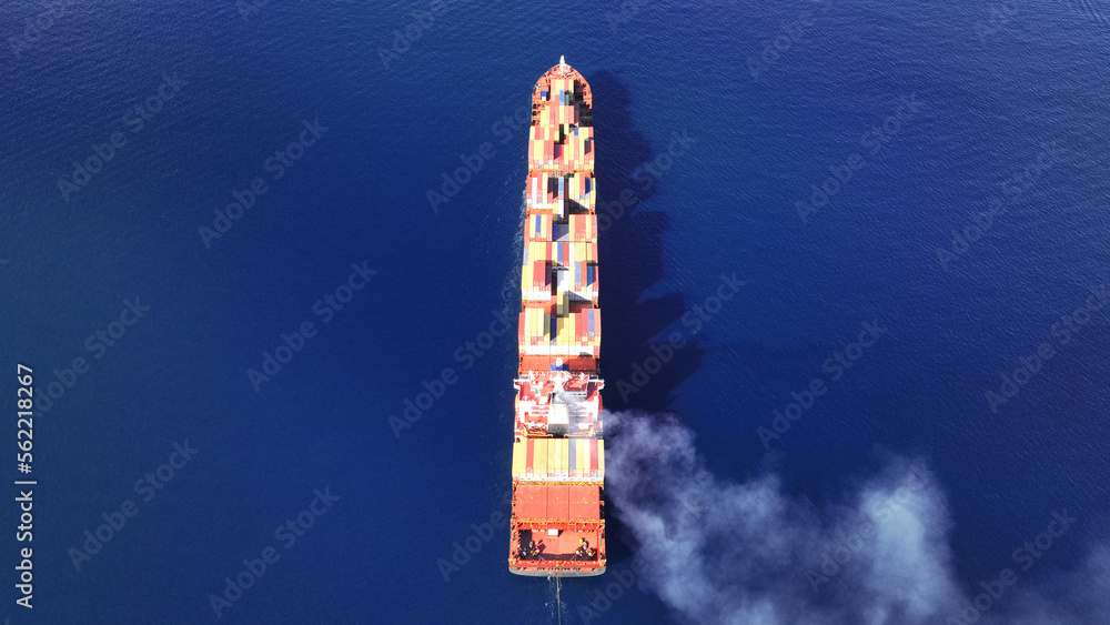 Aerial drone photo of truck size container cargo vessel cruising in ...