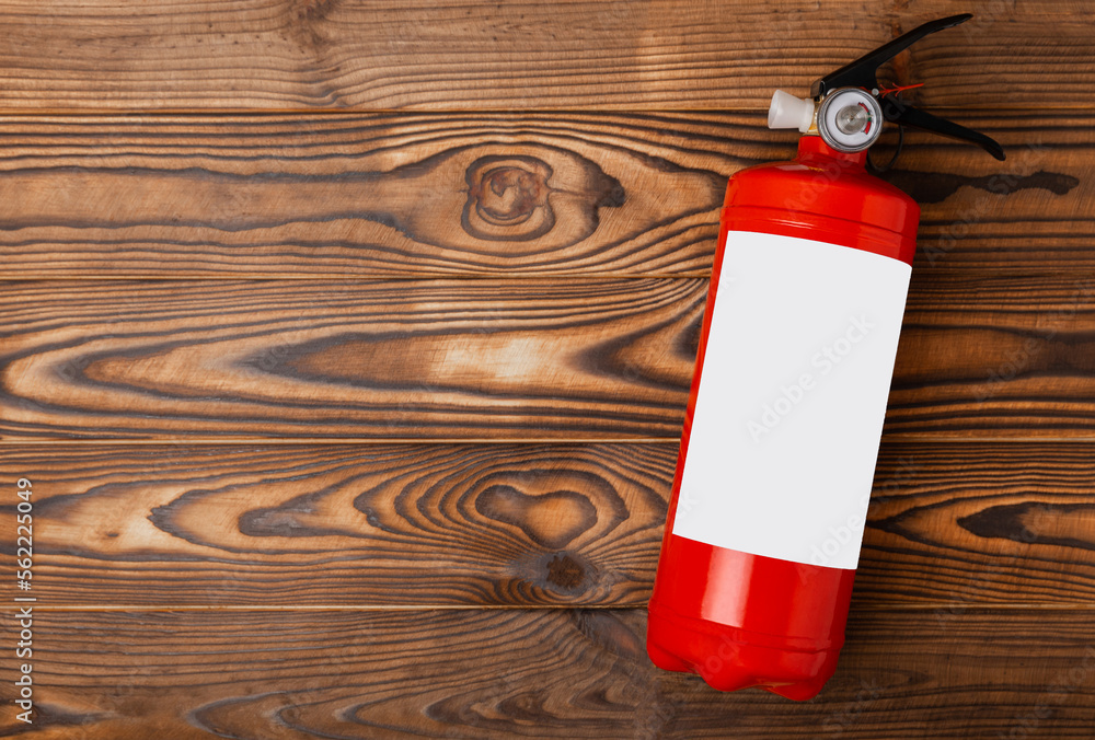 Fire extinguisher on brown wood background. Fire protection, home fire ...