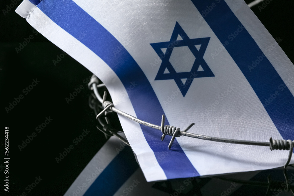 Flag of Israel and barbed wire on dark background. International ...