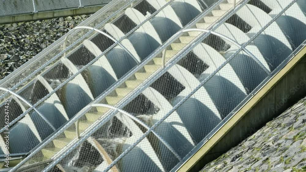 Closeup of grey turning metal screw pumps to pump water from low to ...